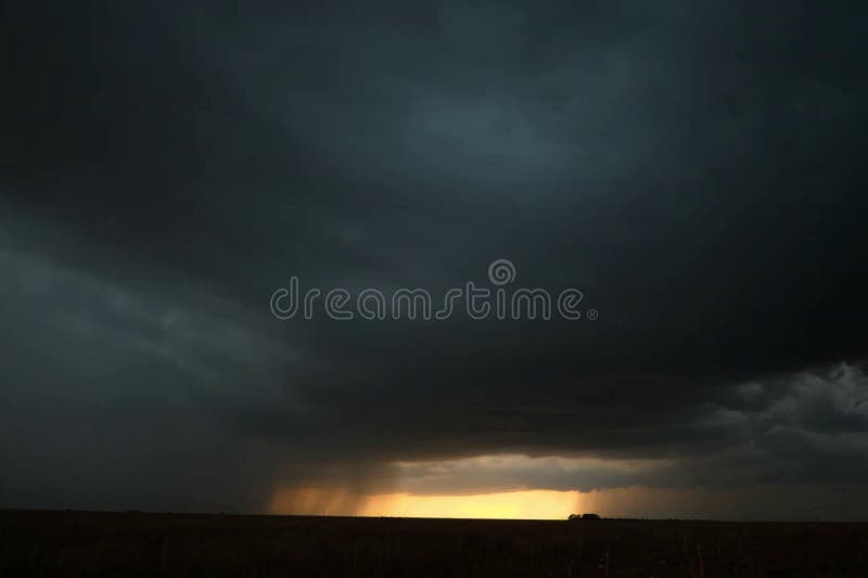 Twilight Tempest: Sunset Silhouetted by Darkened Clouds Stock Photo - Image of lighting ...