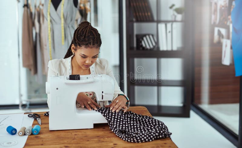 The Final Stitch. a Young Fashion Designer Using a Sewing Machine in ...