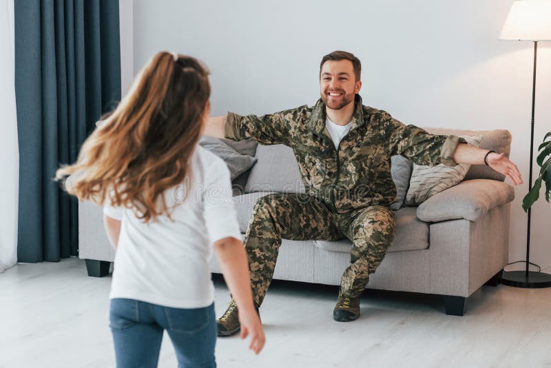 Finally at Home. Soldier in Uniform is with His Little Daughter Stock ...