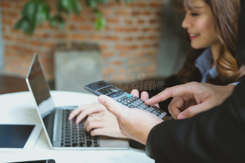Financial Adviser Working with Calculator & Computer at Office. Stock ...