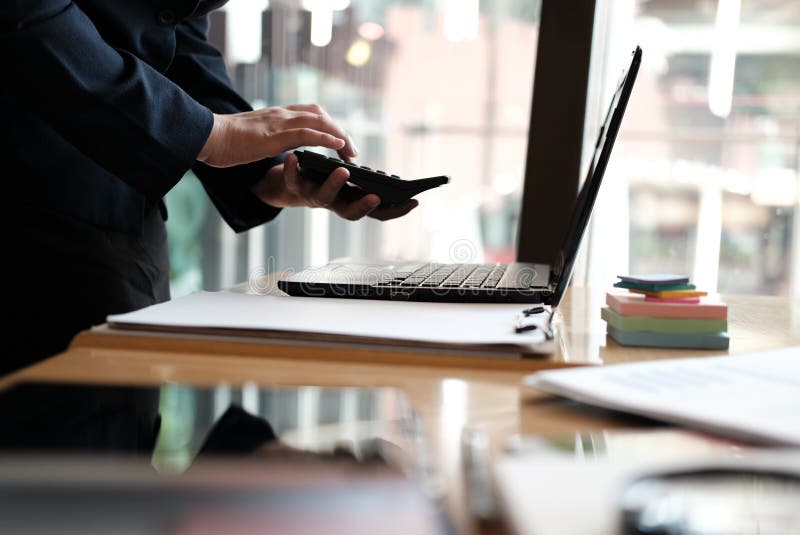 Financial Adviser Working with Calculator & Computer at Office. Stock ...
