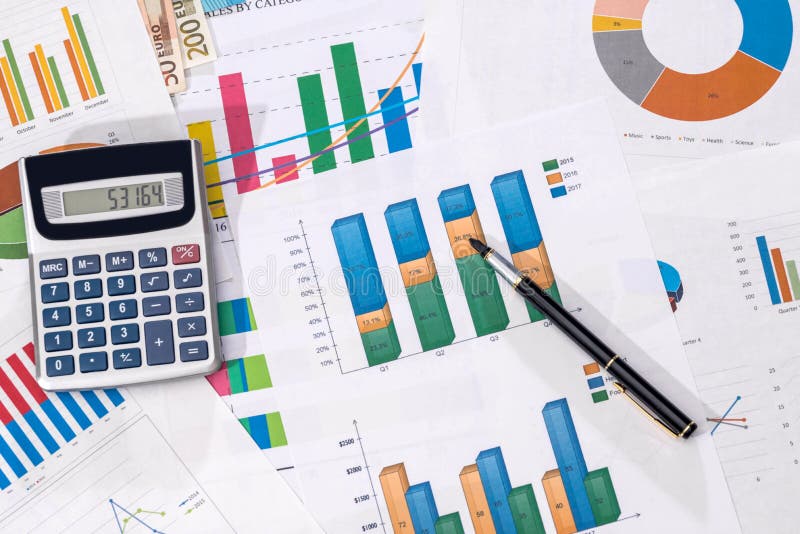 Analysis of the Annual Budget with Calculator and Money on the Table ...