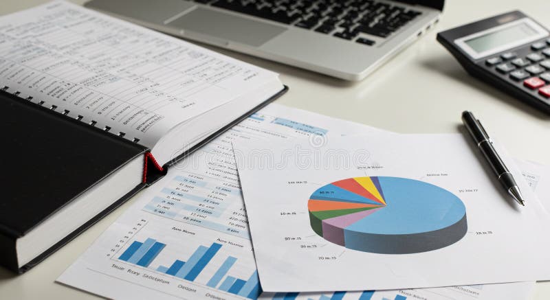 Financial Analysis Workspace with Charts, Laptop, and Accounting Tools ...
