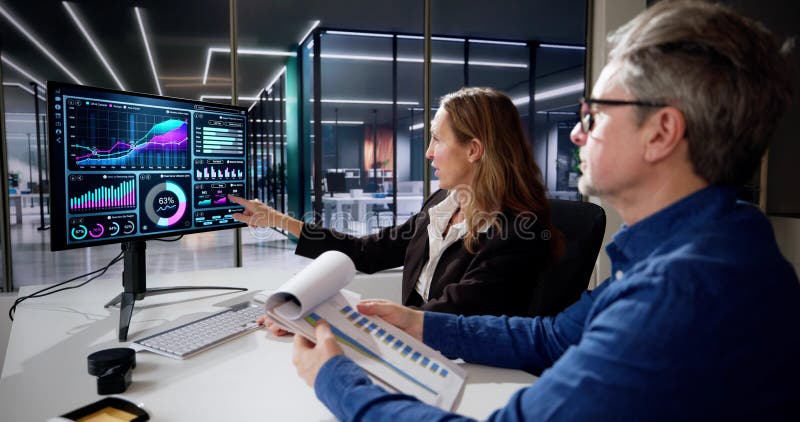 Financial Analyst Working on Computer with Multi-Monitor Workstation ...