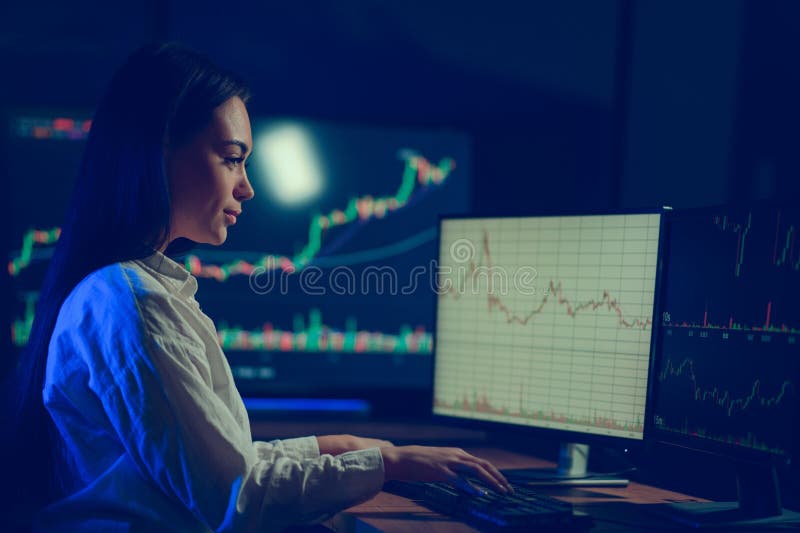 Financial Analyst Working on a Computer with Multi-Monitor Workstation ...