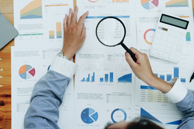 Financial Analysts Analyzing Business Financial Reports are Examining ...