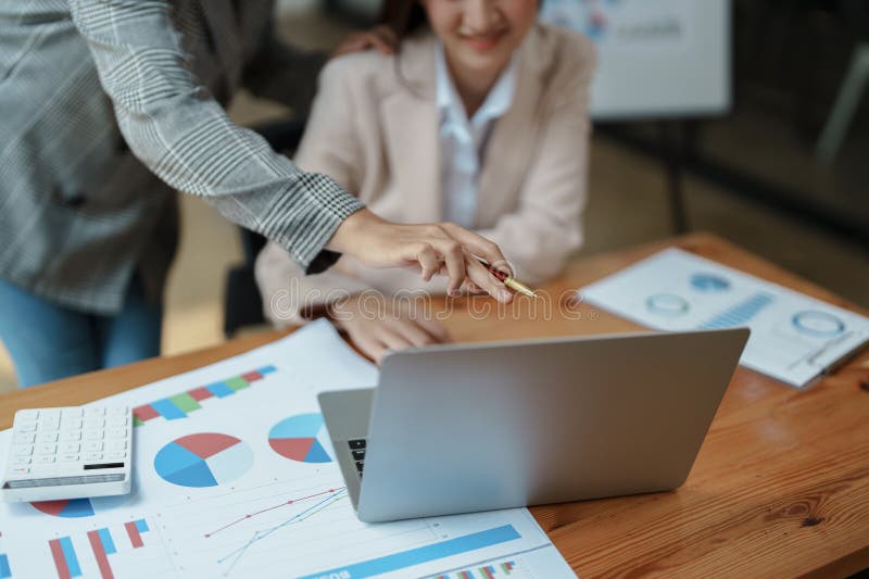 Financial Analysts Analyzing Business Reports on Planned Investment ... Financial Analysts Analyzing Business Reports on Planned Investment ...