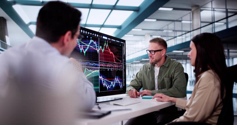 Financial Analysts Analyzing Stock Charts on Computer Screens Stock ...