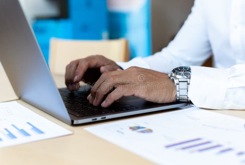 A Financial Businessman, a Young Man Analyzes Financial Data Using a ...