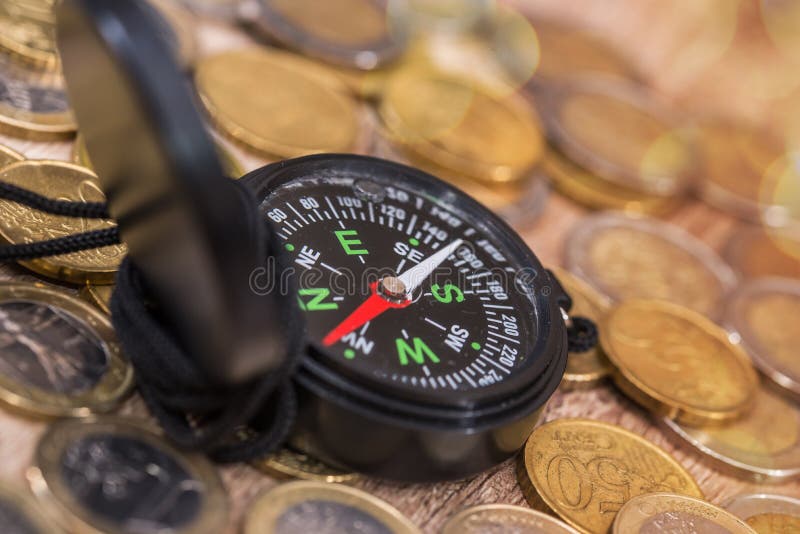 Compass on gold coins stock image. Image of bank, currency - 166767603