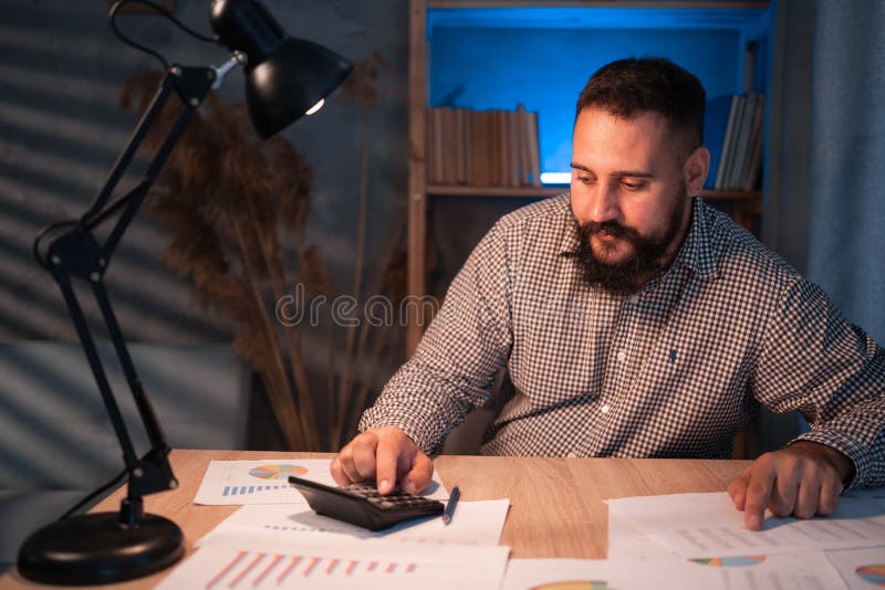Financial Data Analyzing Hand Writing and Counting on Calculator Late ...