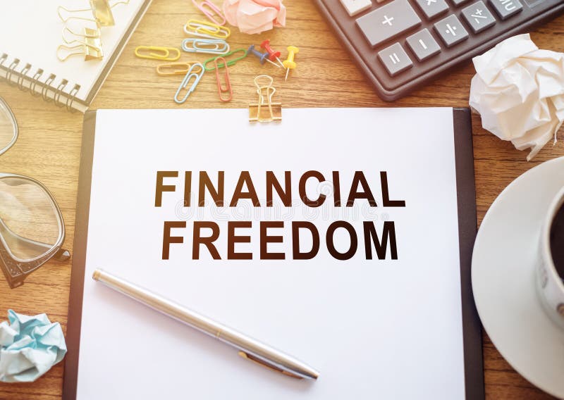 FINANCIAL FREEDOM Text on Notebook with Coffee, Eyeglasses, Calculator ...