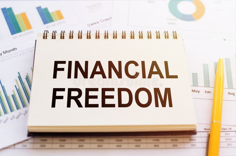 FINANCIAL FREEDOM - Written on Notepad on Financial Charts and Graphs ...