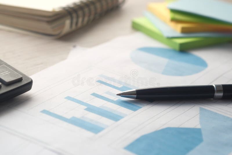Financial Graph, Calculator and Notepad on Table Stock Photo - Image of ...