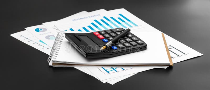 Financial Graphs with Notepad and Calculator on Black Background Stock ...