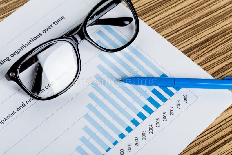 Financial Paper with Charts and Diagrams on Gray Table Stock Photo ...