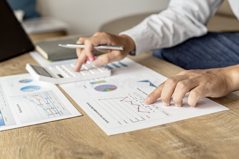 A Financial Scholar is Looking at a Financial Document To Verify the ...