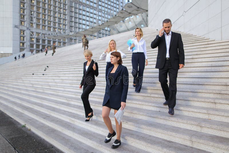 Financial Team Going Down Stairs in with Tablet, Case and Talk Stock ...