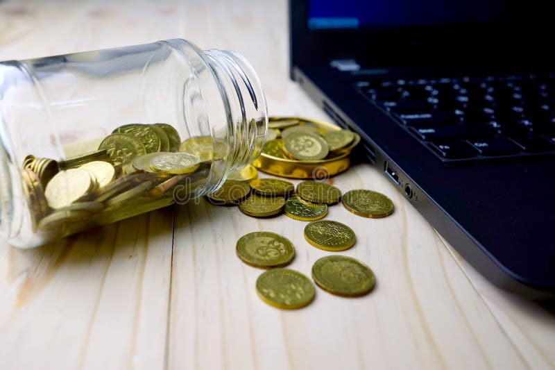 Financing Concept. Golden Coins with Glass Container and Laptop Stock ...