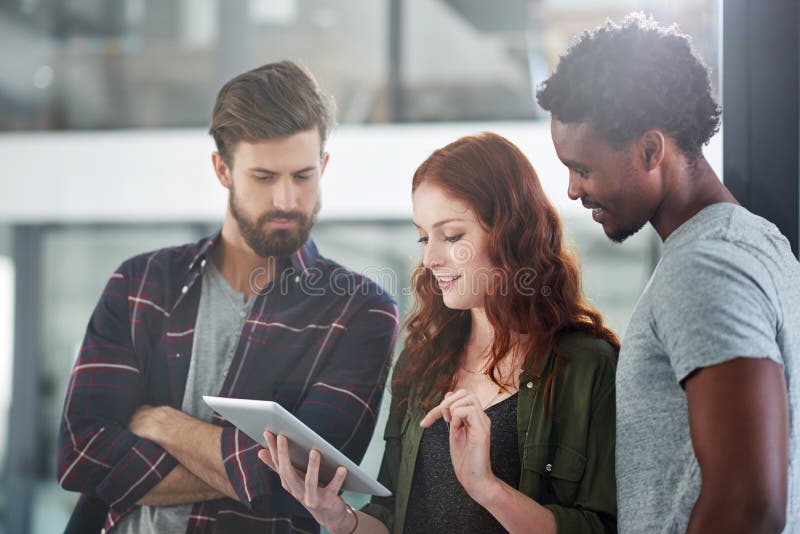 Finding Solutions Online As a Team. Three Young Creatives Working ...