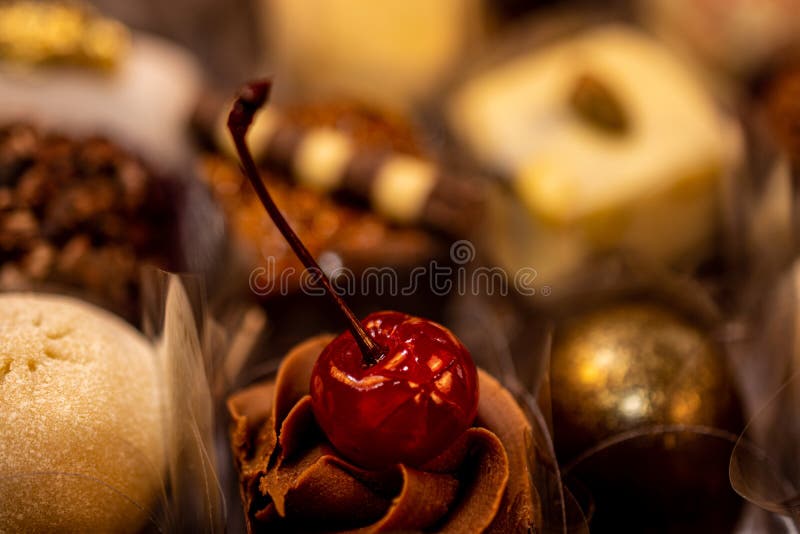 Fine Sweets for Parties with Chocolate and Cherry. Decorated on a ...