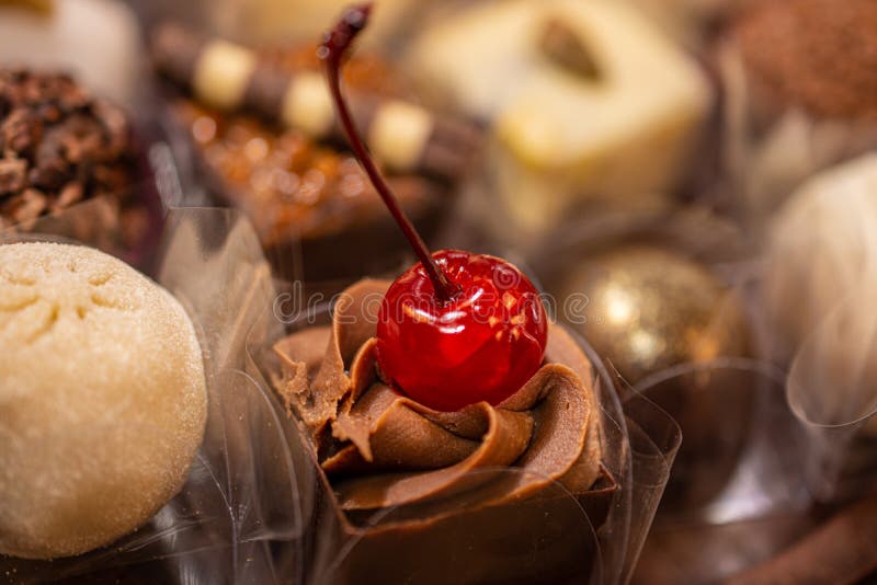 Fine Sweets for Parties with Chocolate and Cherry. Decorated on a ...