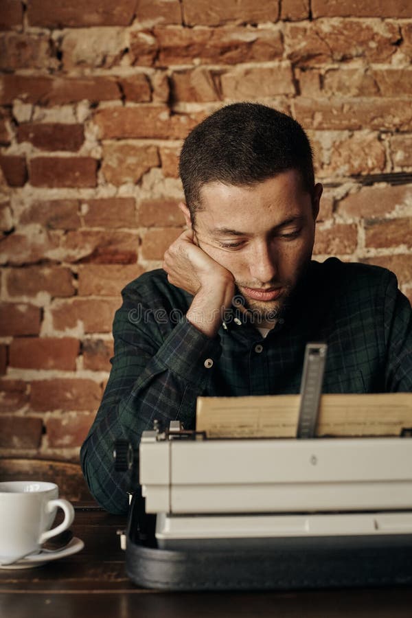 Fine Young Writer Working on a Classic Typewriter. he is Happy and in ...