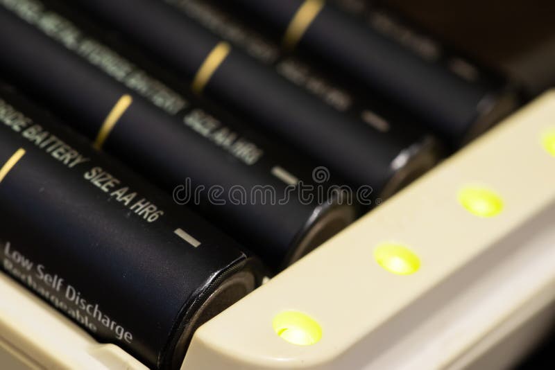 Finger Batteries AA are Charged in the Charger Stock Image - Image of ...