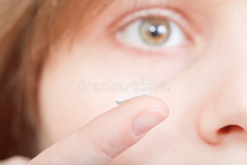 Finger with Corrective Lens in Front of Face Stock Photo - Image of ...