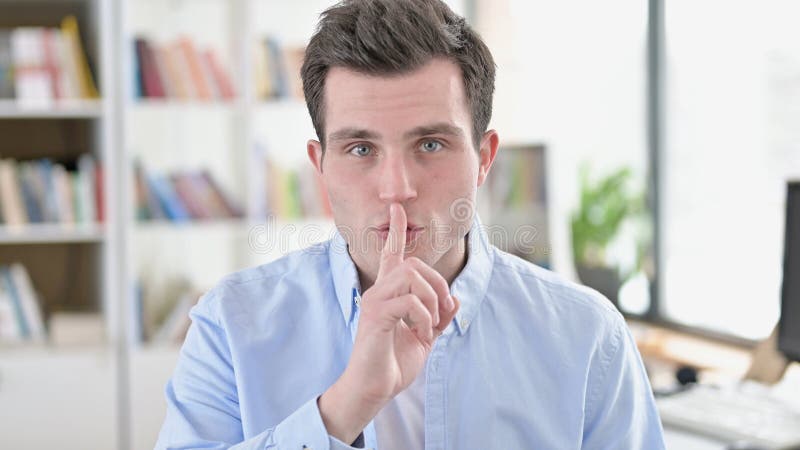 Finger on Lips by Handsome Young Man Stock Photo - Image of shaking ...
