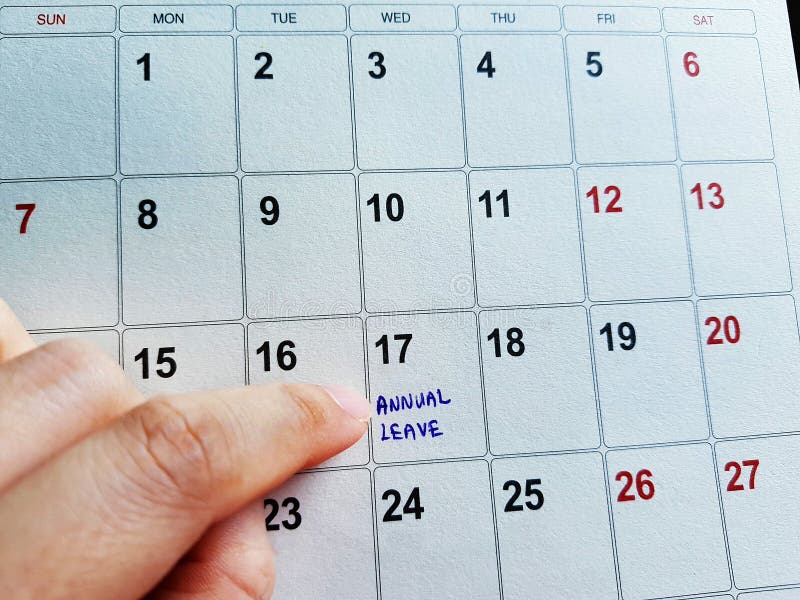 Finger Pointing at a Date on a Calendar, with the Word Annual Leave ...