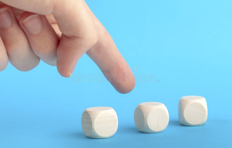 Finger Pointing at One of Three Blank Plain Wooden Blocks, Group of ...