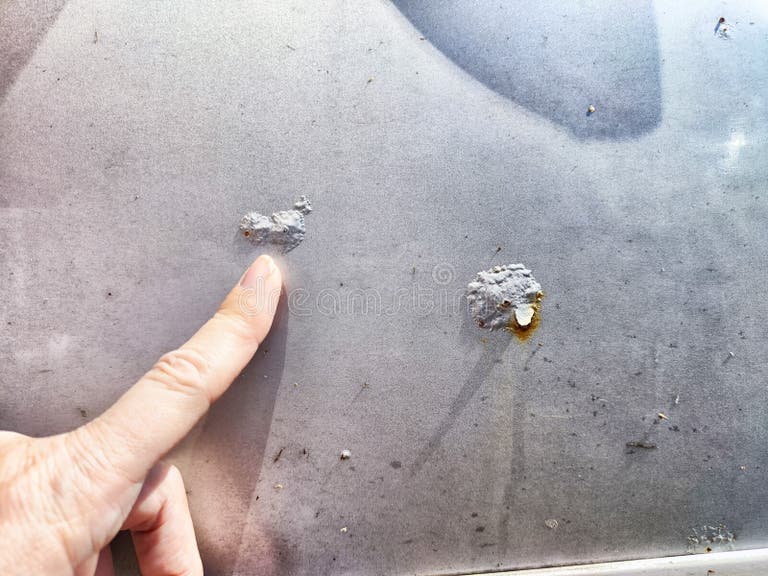 A Finger Points at Two Rust Spots on a Gray Metal Surface Stock Image ...