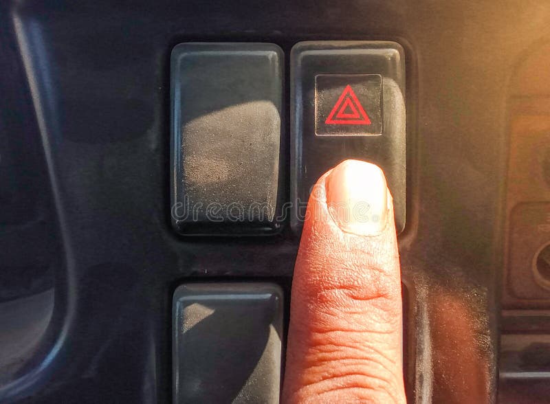 Finger on the Red Triangle Button of a Car`s Hazard Warning Lights ...