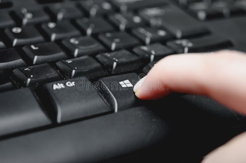Finger Pressing the Windows Key from a Dusty Black Keyboard. Editorial ...