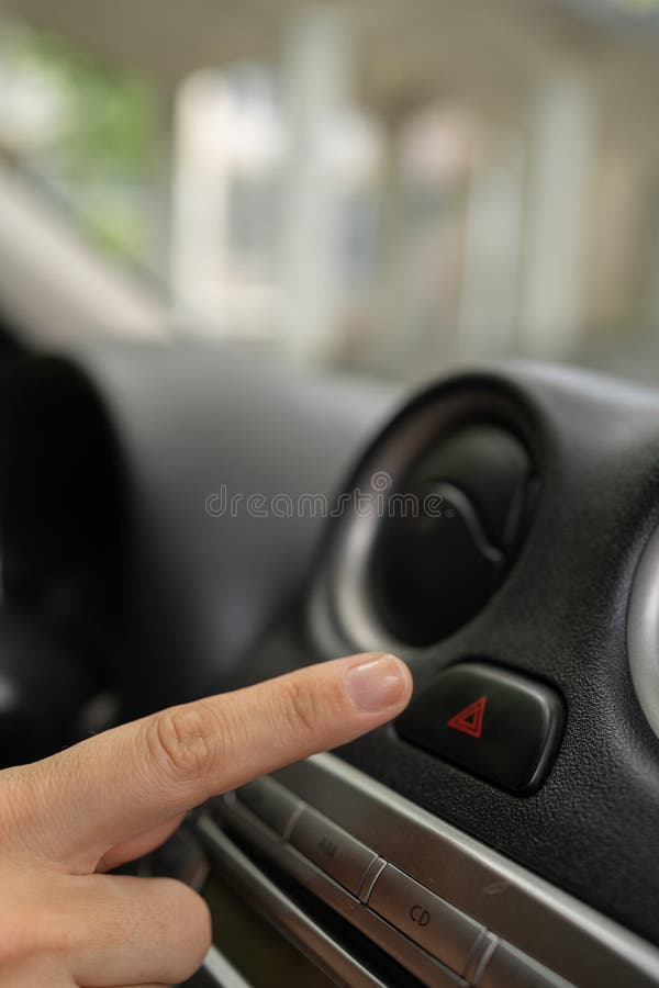 Finger Pushes a Triangle Emergency Button on Car Dashboard. Close Up ...