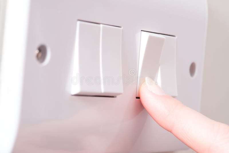Finger Pushing Light Switch on a 4 Gang Switch Plate Stock Photo ...