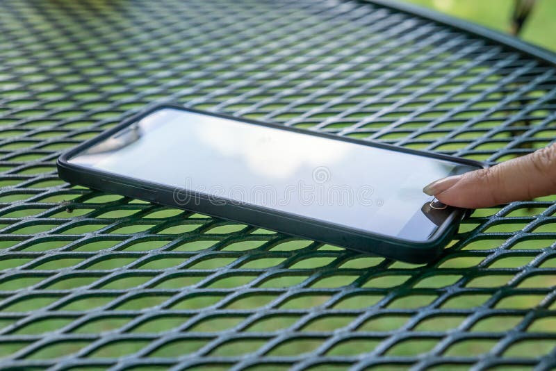 Finger Tapping on Off Button on Smart Cell Phone. Outside Resting on ...