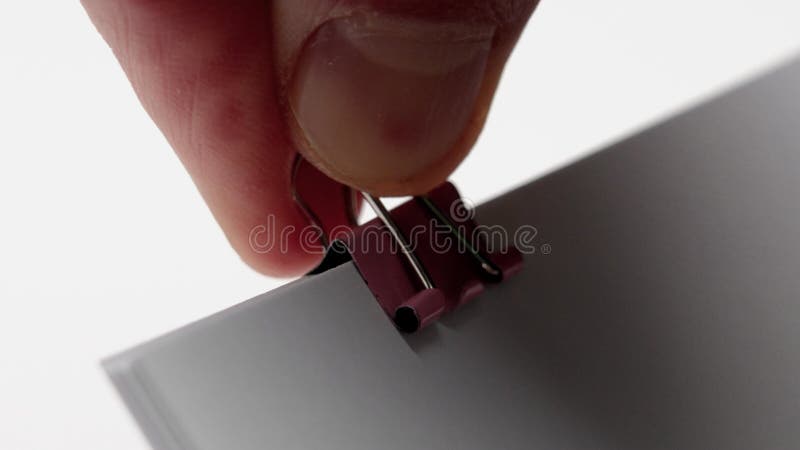 Fingers Attaching a Office Metal Binder Clip To a Bundle of Paper ...
