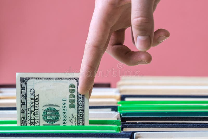 Fingers Pulling Money Out of Book Pages Stock Photo - Image of ...