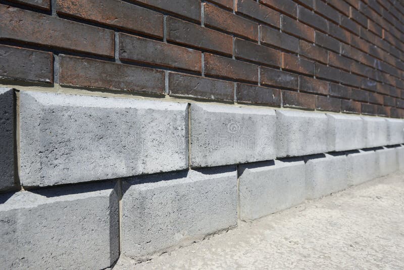 Finishing the Foundation of the House with Gray Block Tiles Stock Photo ...