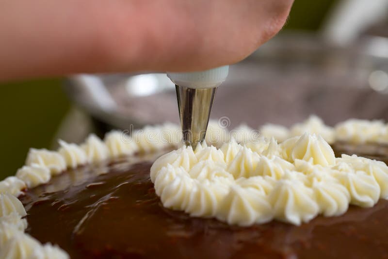Finishing up the cake stock image. Image of garnish - 109791069