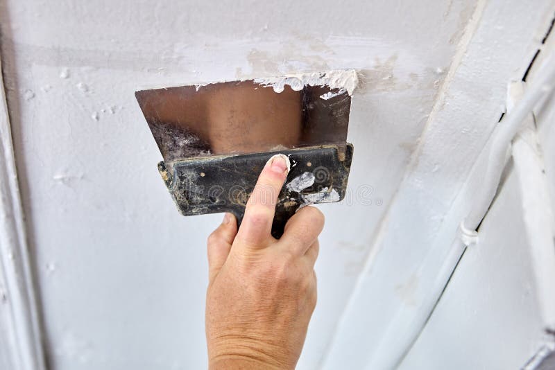 Puttying Ceiling during Finishing Work at Home with Steel Trowel. Stock ...