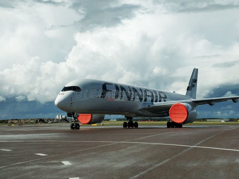 Finnair Plane on the Runway Against the Background of the Cloudy Sky ...