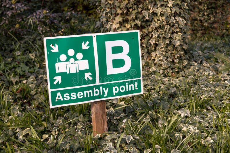 Fire assembly point sign stock image. Image of pole, background - 33589261