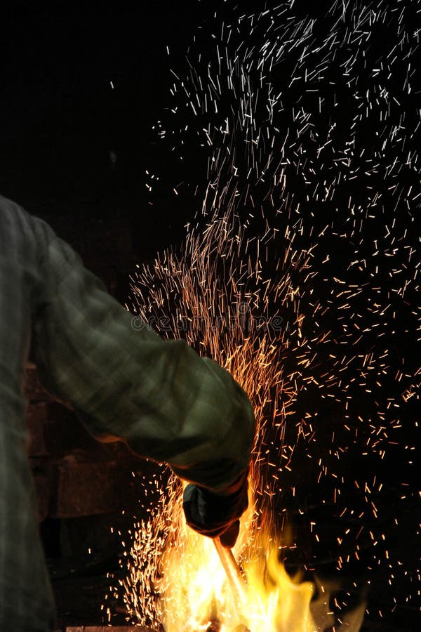 Fire on a Blacksmith. Blacksmith at Work. Dark Background. Splinters of ...