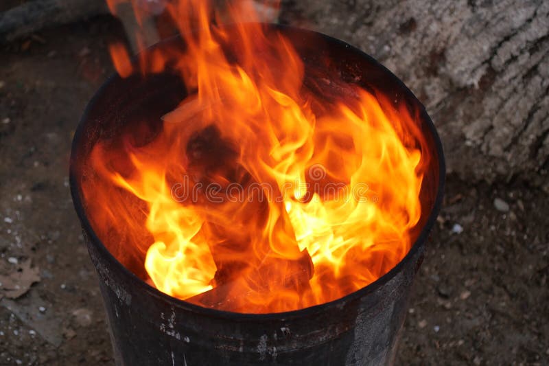 Fire Blazing in a Metal Container Outdoors during Daylight Hours Stock ...