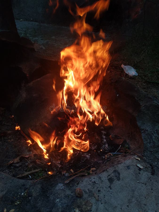 A fire blazing in the wind stock image. Image of burning - 210447585