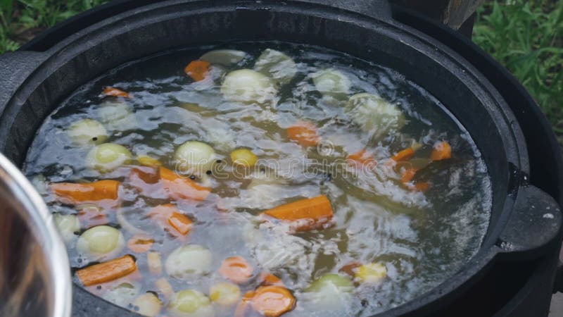 On the Fire is a Brazier with Boiling Water and Vegetables. Stock ...