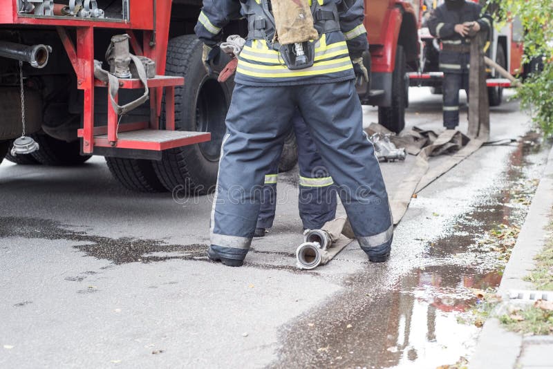 Fire Brigade Works on a Machine with a Hose. View from the Back Stock ...